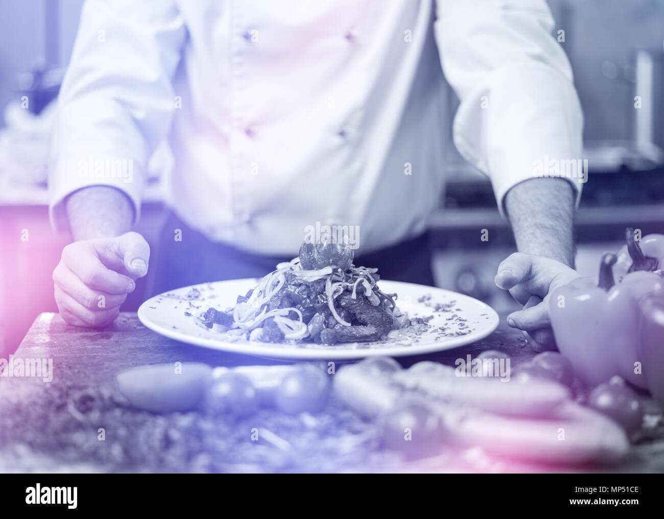 cook chef decorating garnishing prepared meal dish on the plate in ...