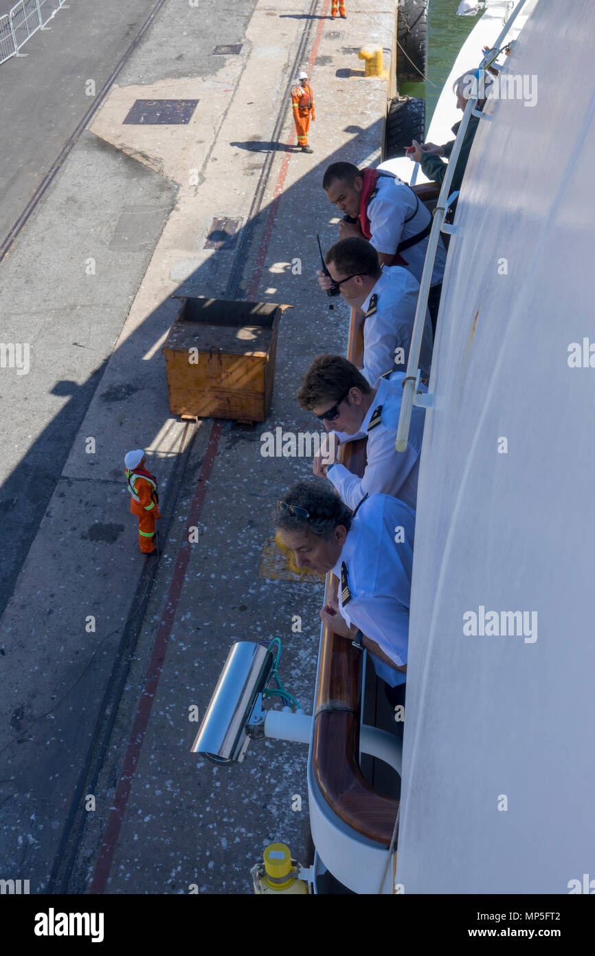 Ship officers monitoring a cruise ship docking at the wharf at Cape ...