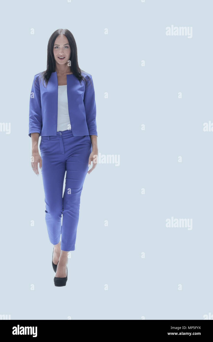 full length portrait of business woman walking towards camera and ...