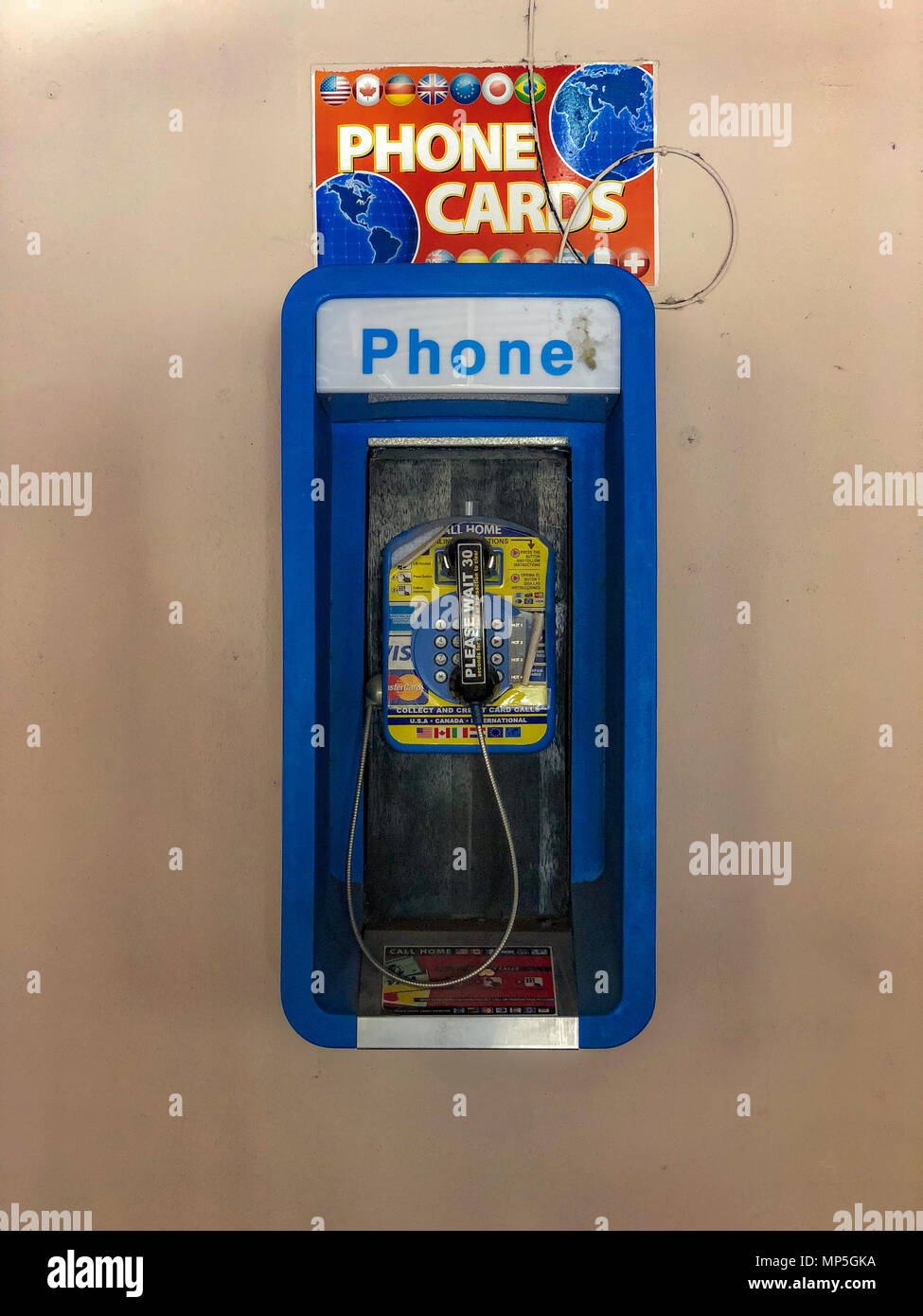 Blue Global Pay Phone Stock Photo - Alamy