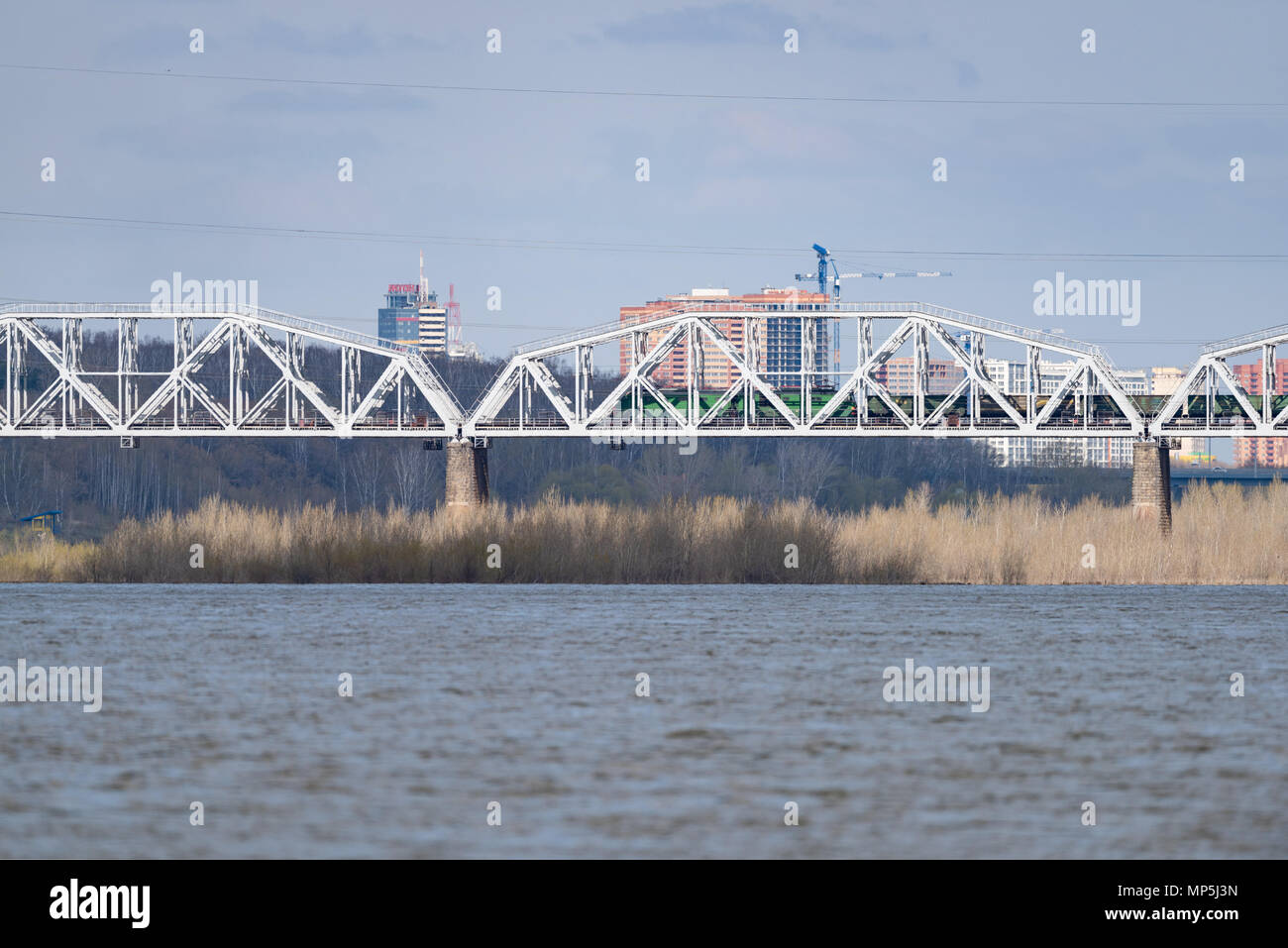 a freight train is driving across a bridge across the river Stock Photo ...