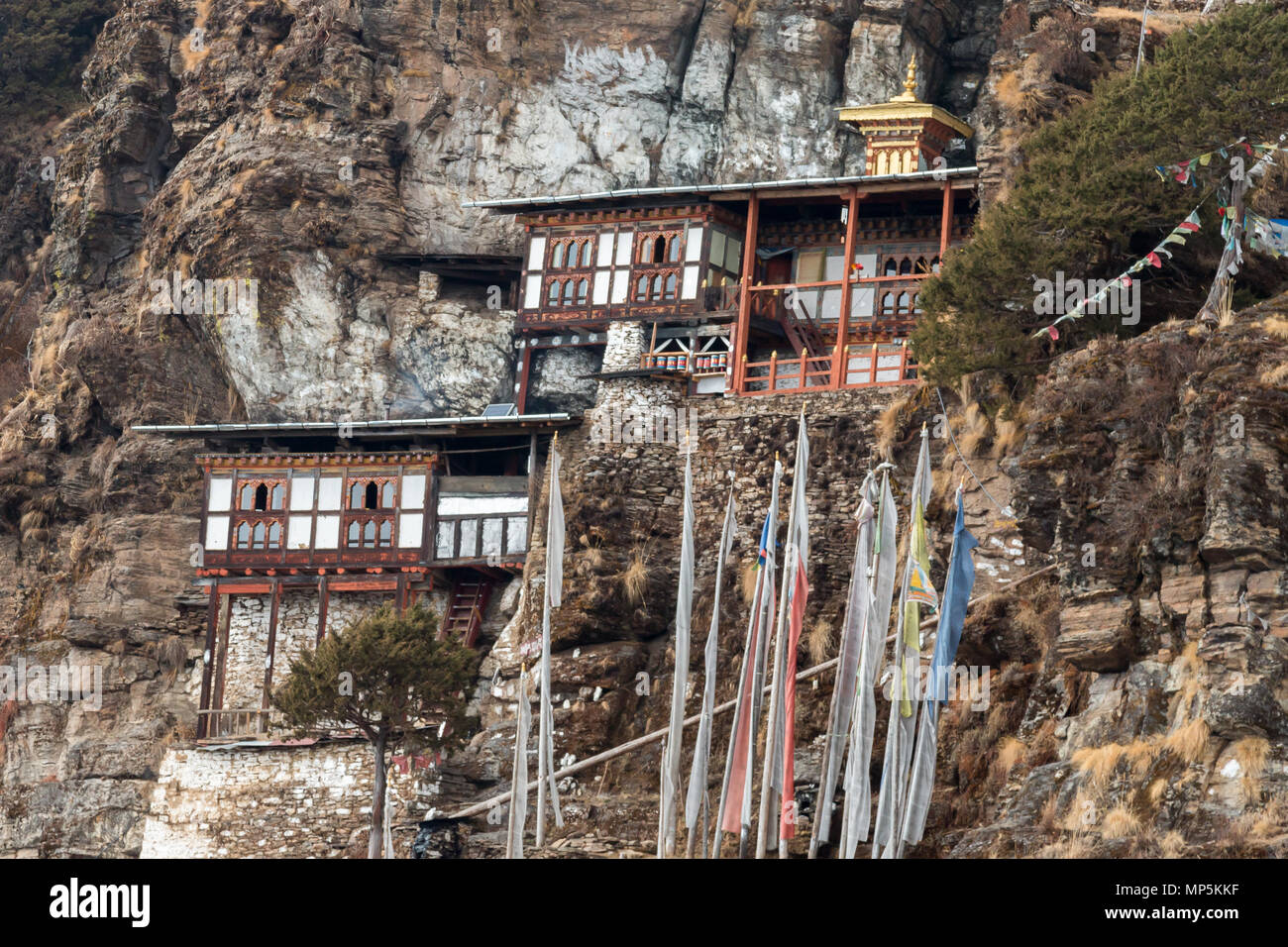 Remote, isolated Buddhist temple built into a cliff face, seen while ...