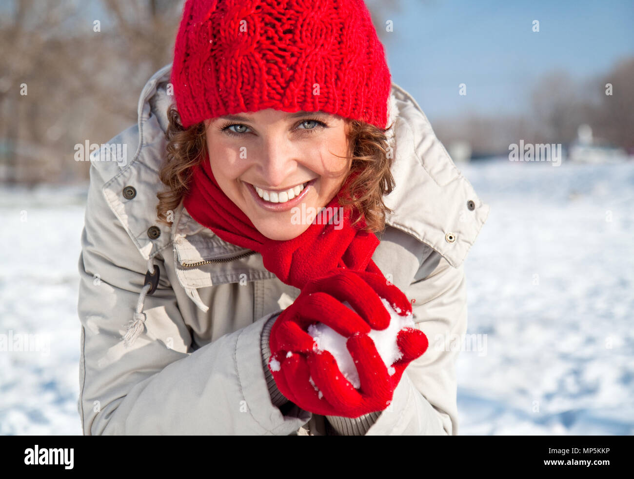 Happy young woman playing snowball fight on the snow sunny day Stock ...