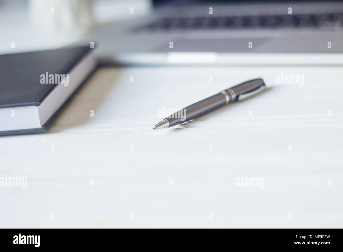 pen and a notebook at the workplace Stock Photo - Alamy