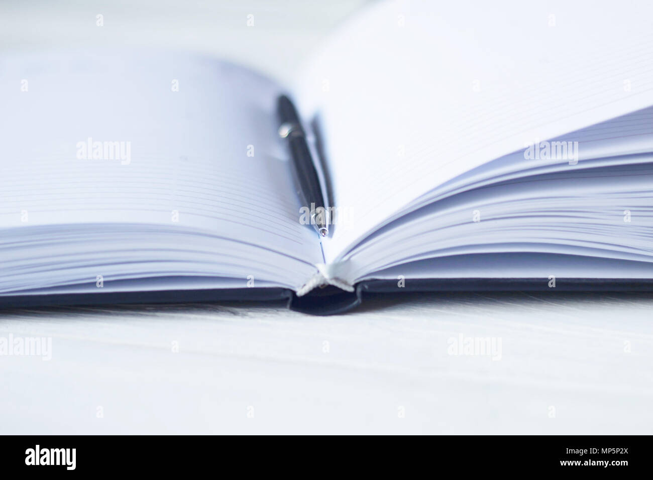 pen and a notebook at the workplace Stock Photo - Alamy