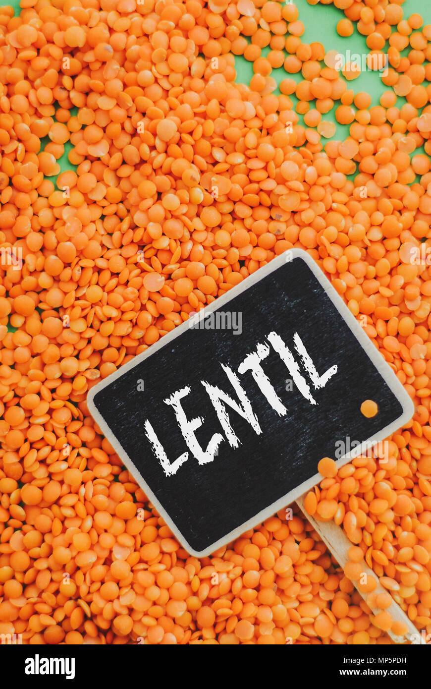 orange lentils and chalkboard with word lentil Stock Photo - Alamy