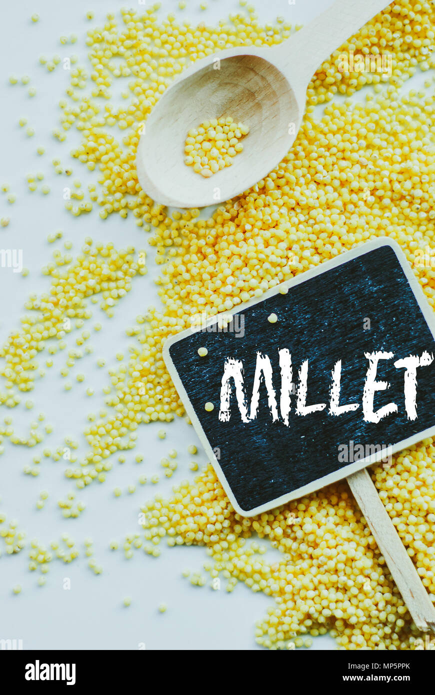 organic millet seeds and chalkboard with word millet on white ...