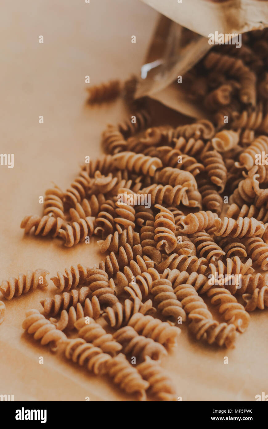 wholemeal pasta fusilli from organic whole grain spelt falling from a ...