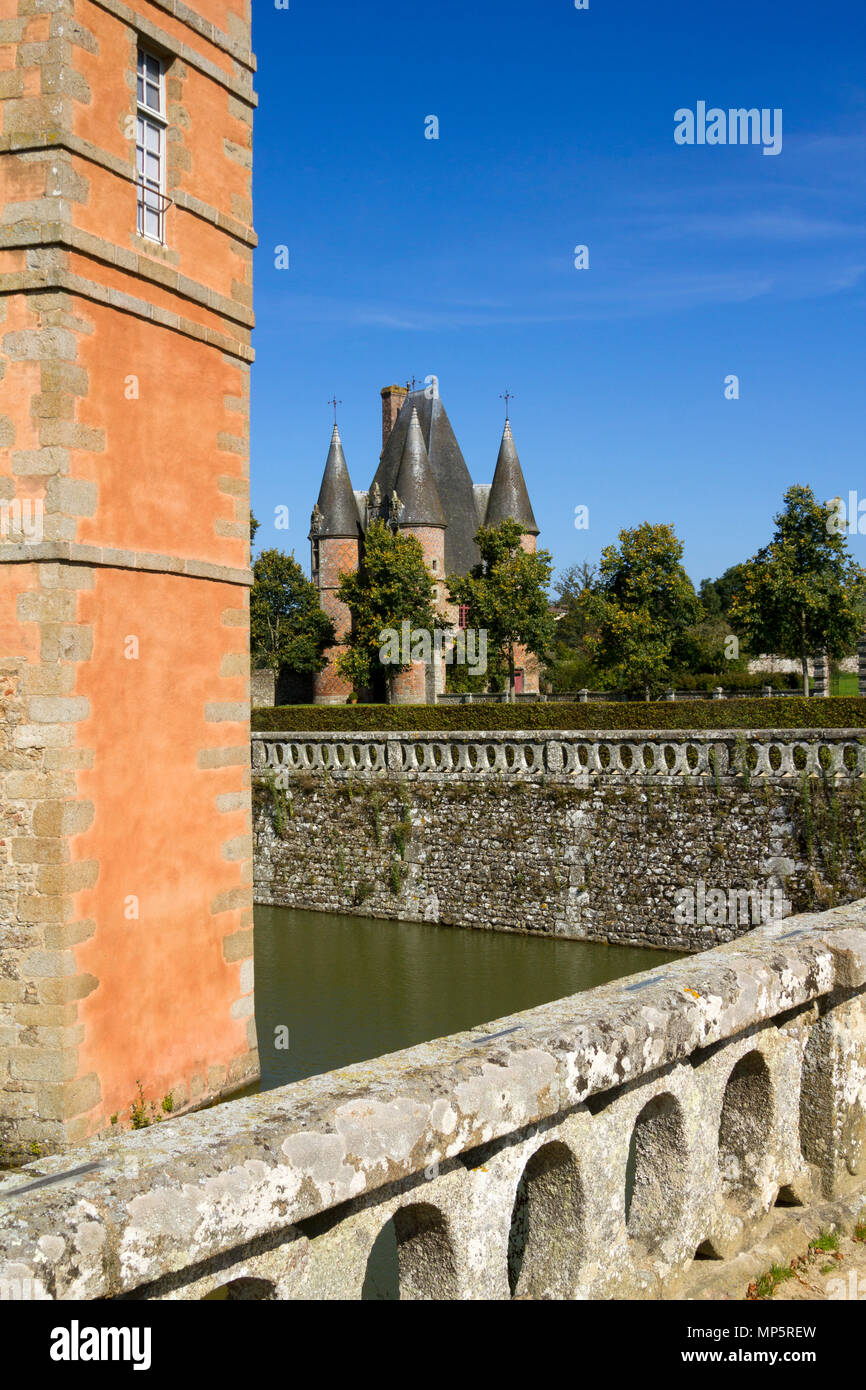 The moat and gatehouse in the distance at Chateau de Carrouges ...