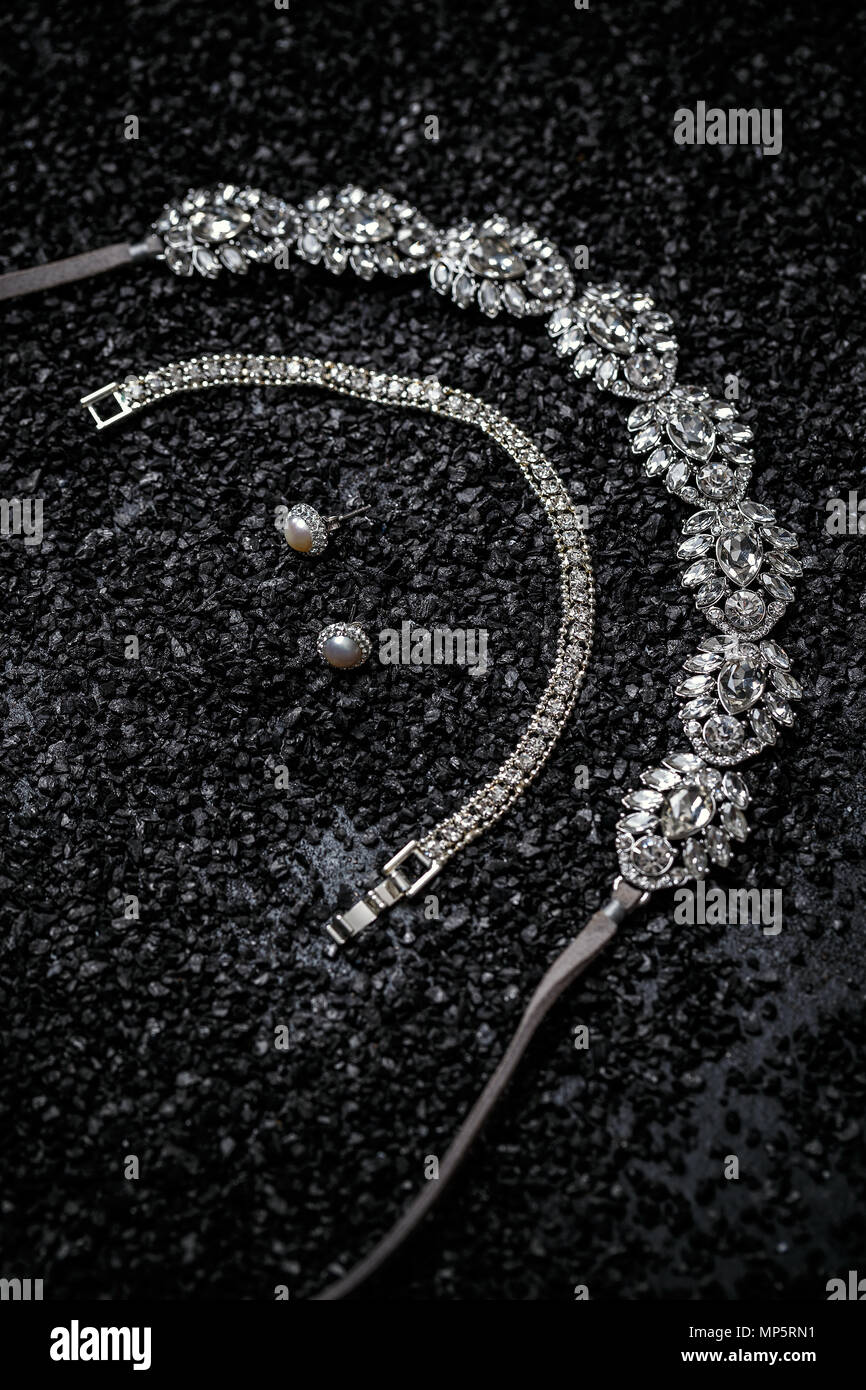 Female jewelry on a black background Stock Photo - Alamy