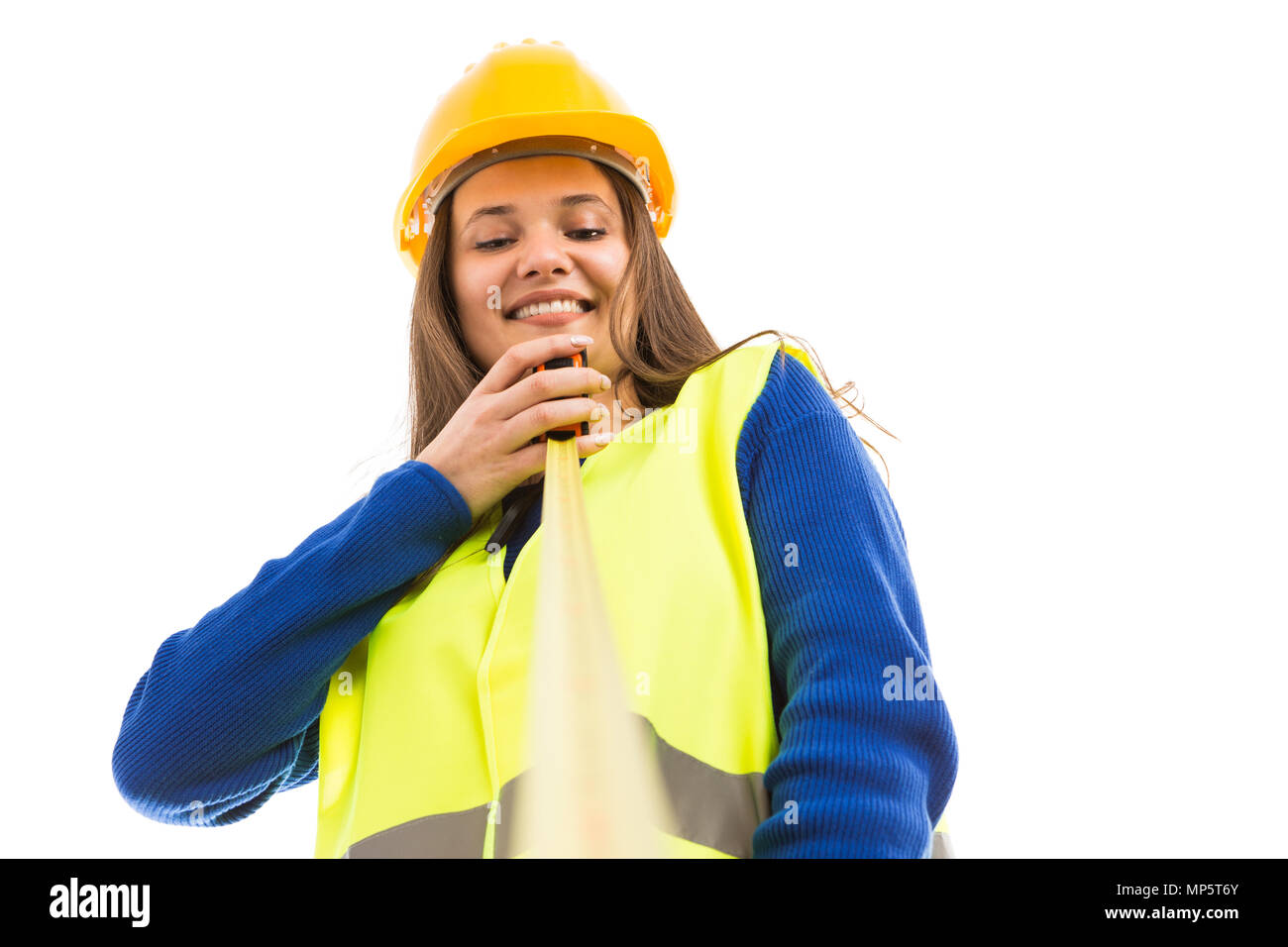 Young female engineer or architect holding measuring tape as ...