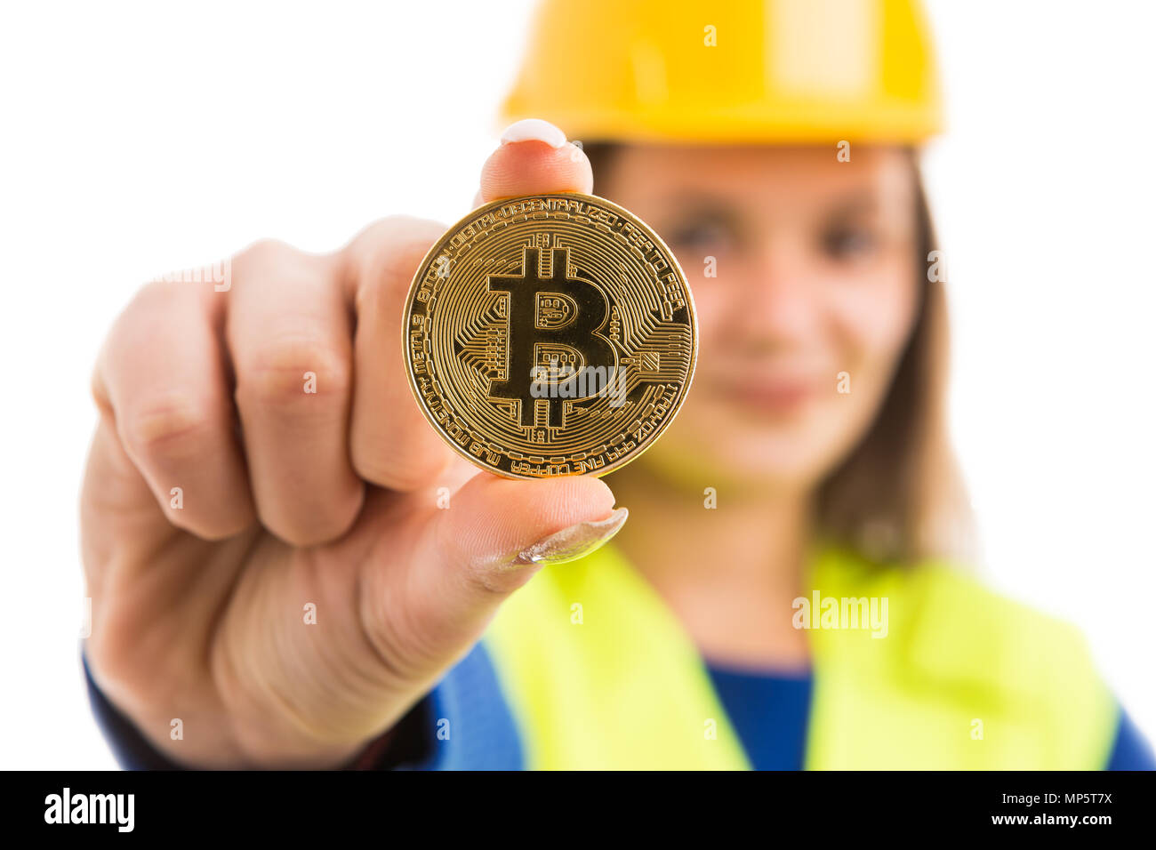 Young female architect or engineer holding golden bitcoin symbol as ...