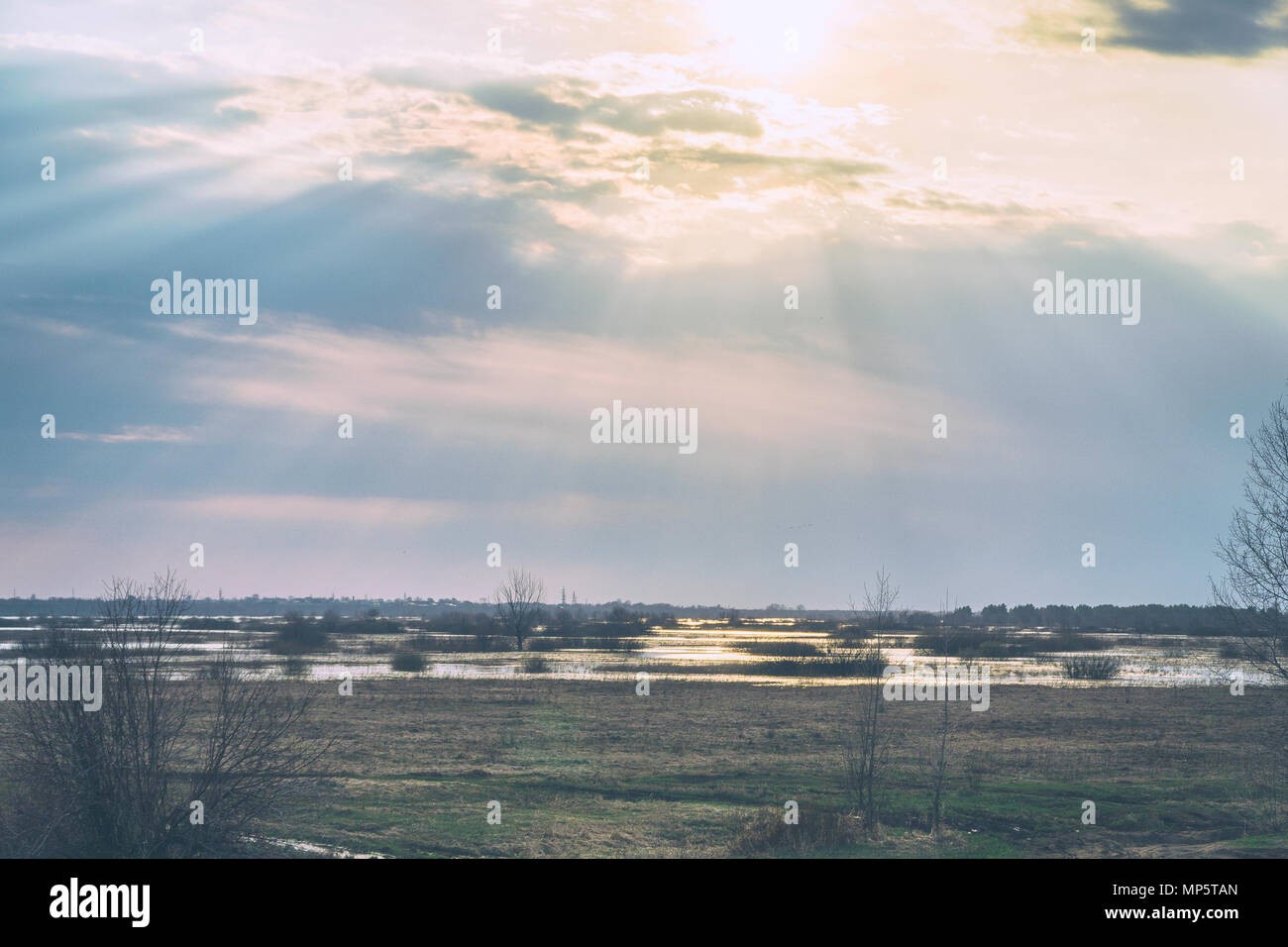 The sun shines through the rain clouds Stock Photo - Alamy