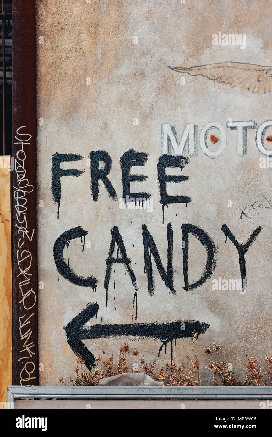 Creepy sign of free candy painted on a wall Stock Photo - Alamy