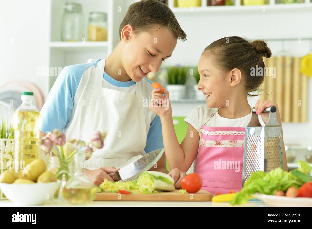 brother and sister in the kitchen preparing Stock Photo - Alamy
