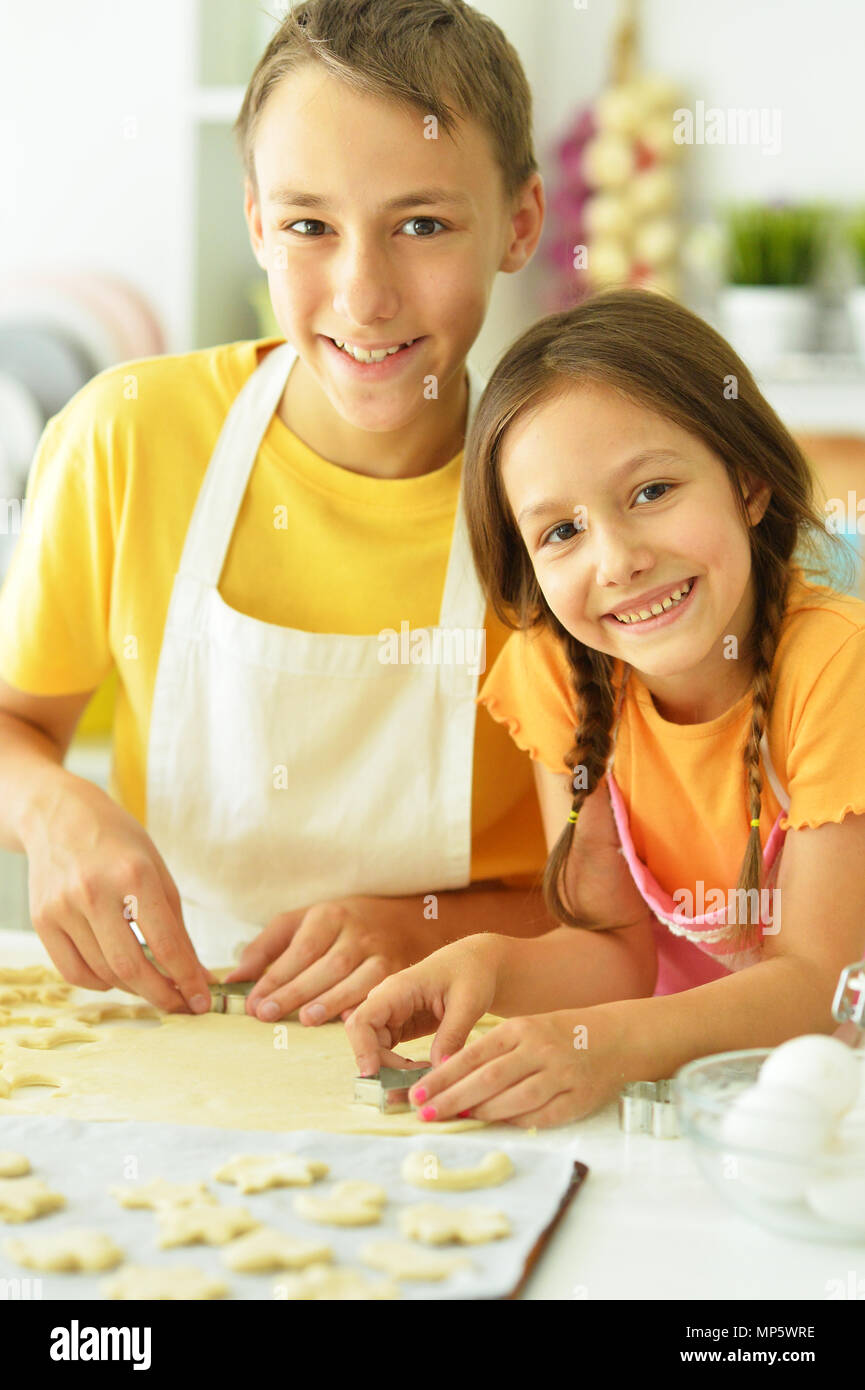 brother and sister in the kitchen preparing Stock Photo - Alamy