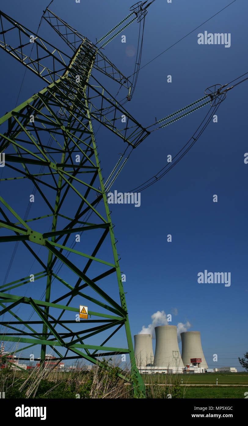 Tall green electricity pylon with power plant in background Stock Photo ...