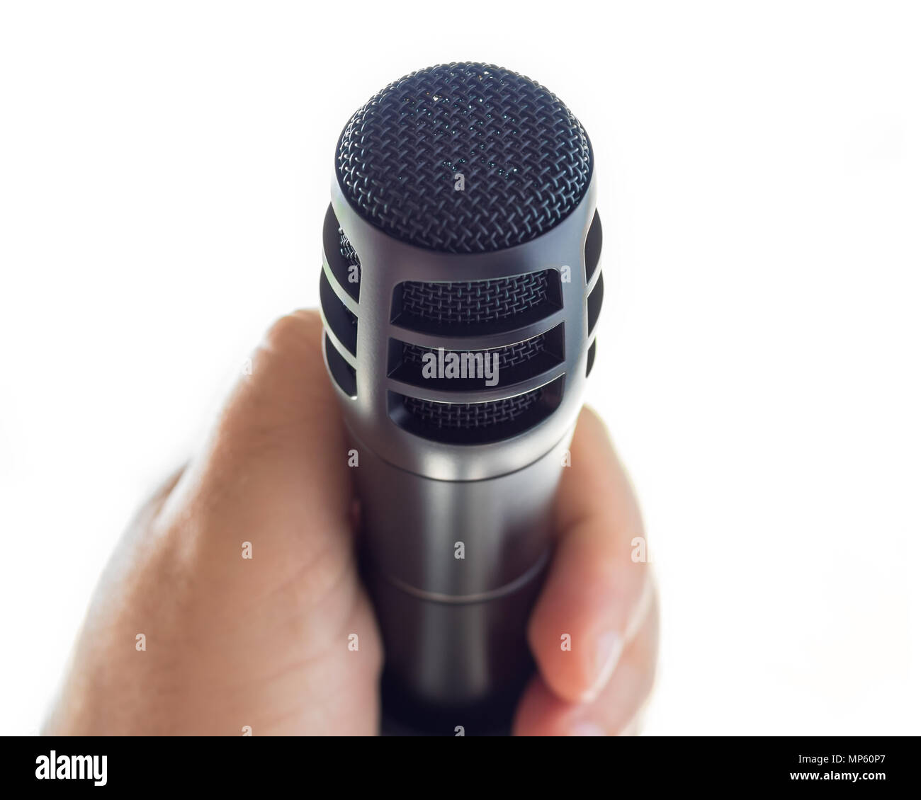 A sleek black microphone on a stand in front of open white space. The ...