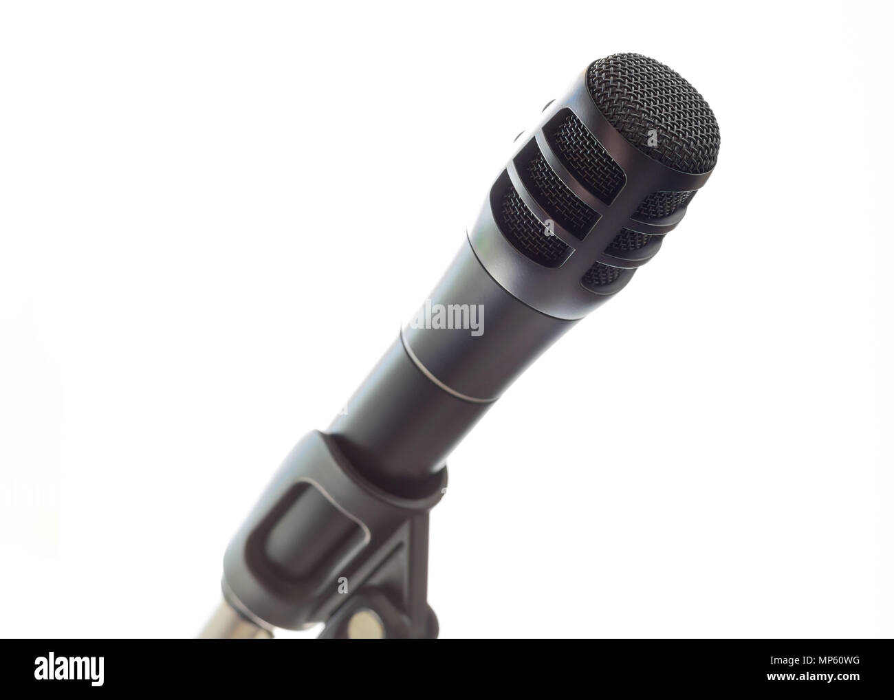 A sleek black microphone on a stand in front of open white space Stock ...