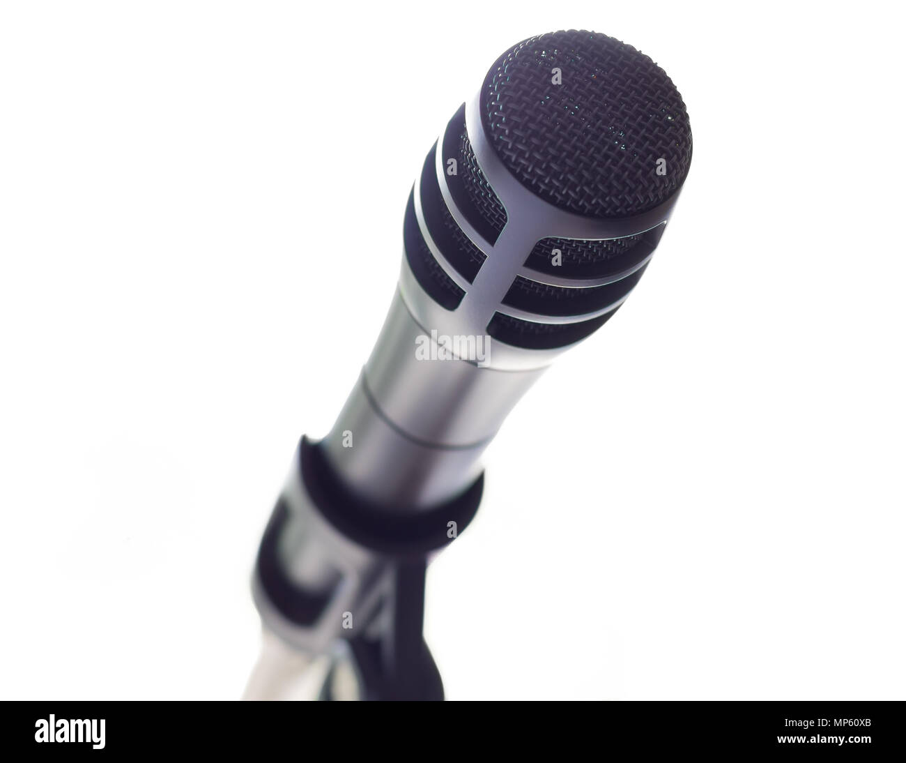 A sleek black microphone on a stand in front of open white space Stock ...