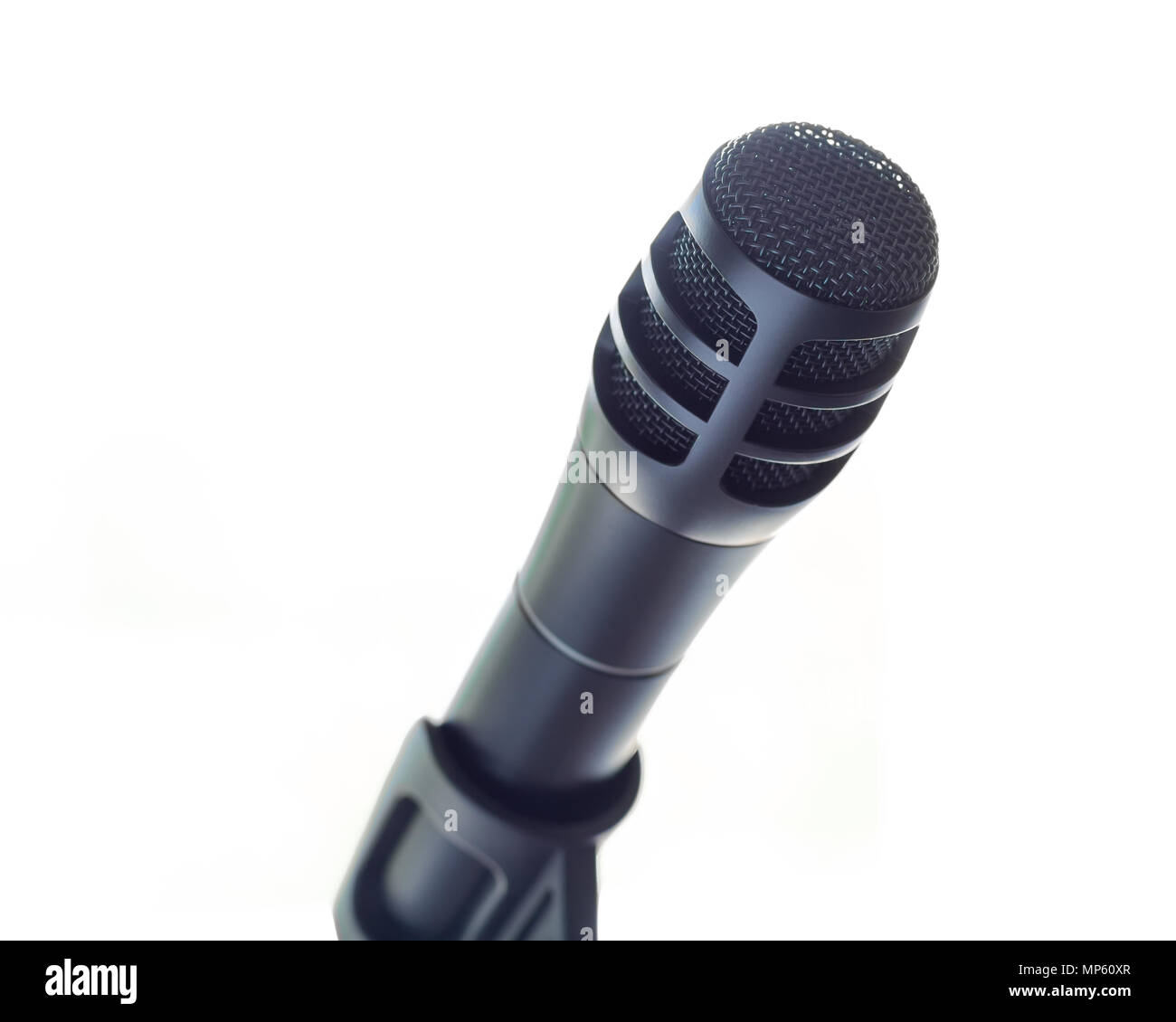 A sleek black microphone on a stand in front of open white space Stock ...