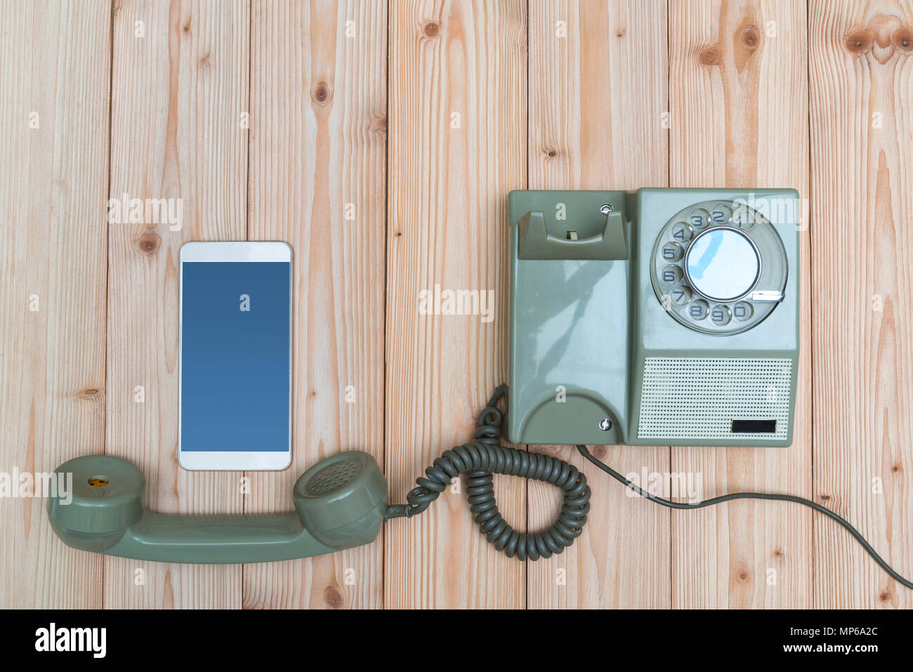 Retro rotary telephone or vintage phone with cable and new cell phone ...