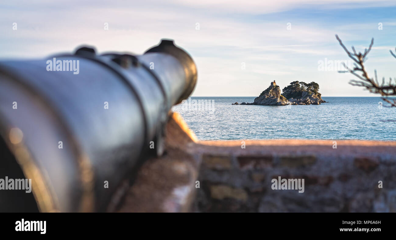 Medieval cannon gun directed on the old Monastery, walls of the old ...
