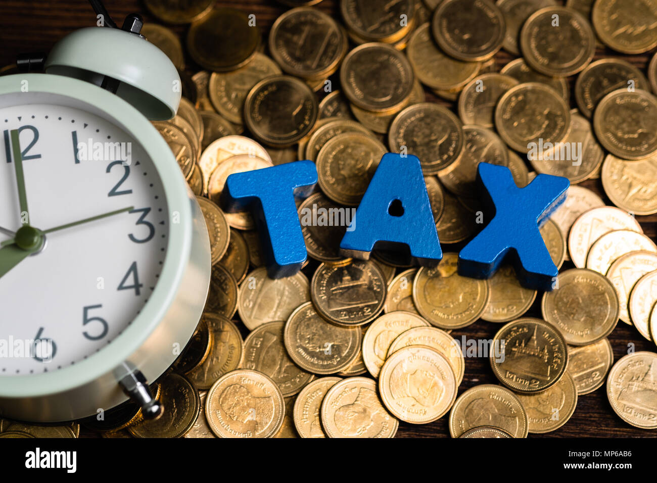 Time to pay TAX concept. TAX alphabet with stack of coin and vintage ...