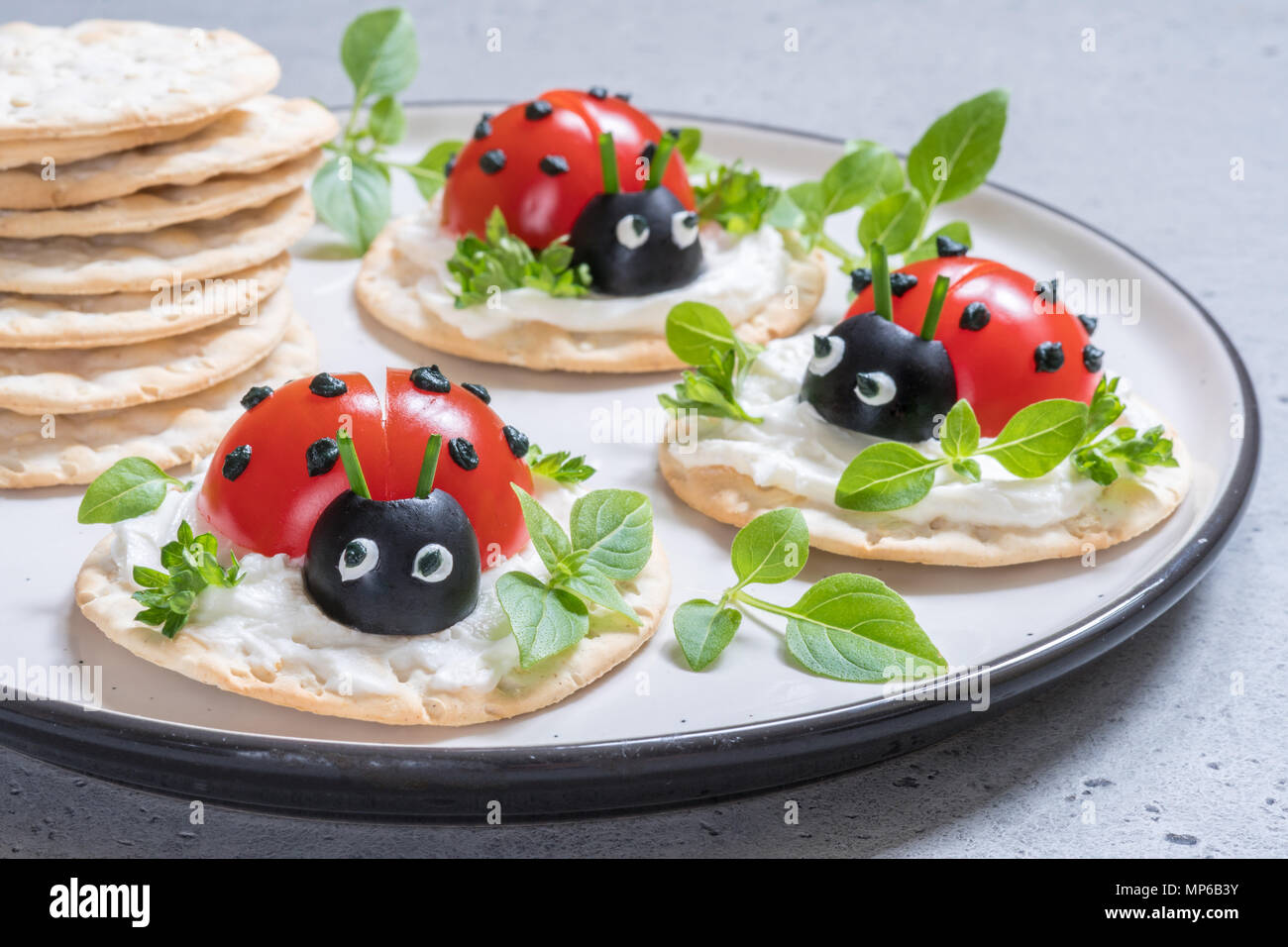 Funny Ladybird Snack Appetizer with Tomato on Crackers Stock Photo - Alamy