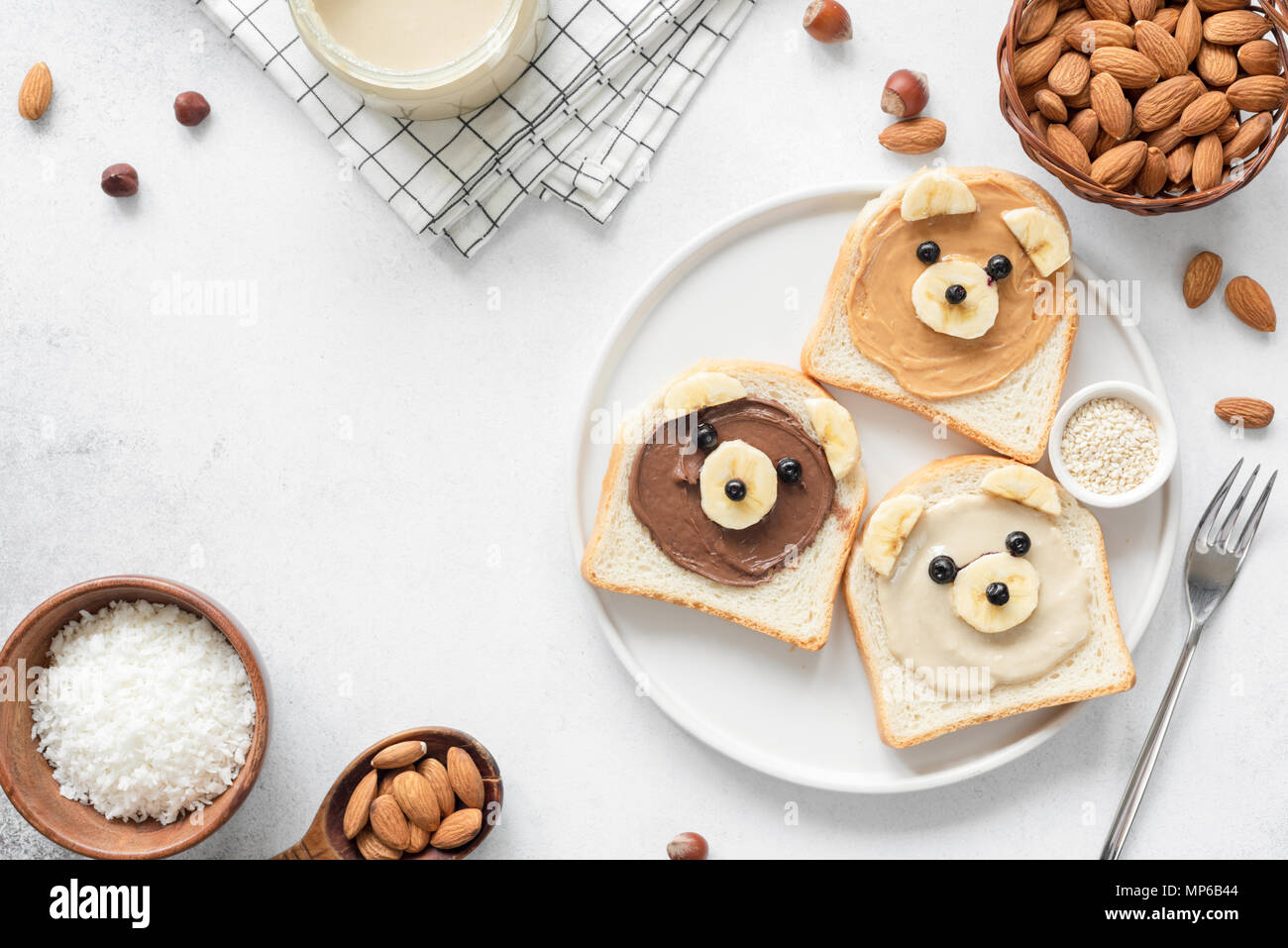 Animal face breakfast toasts with nut butter for kids on concrete ...
