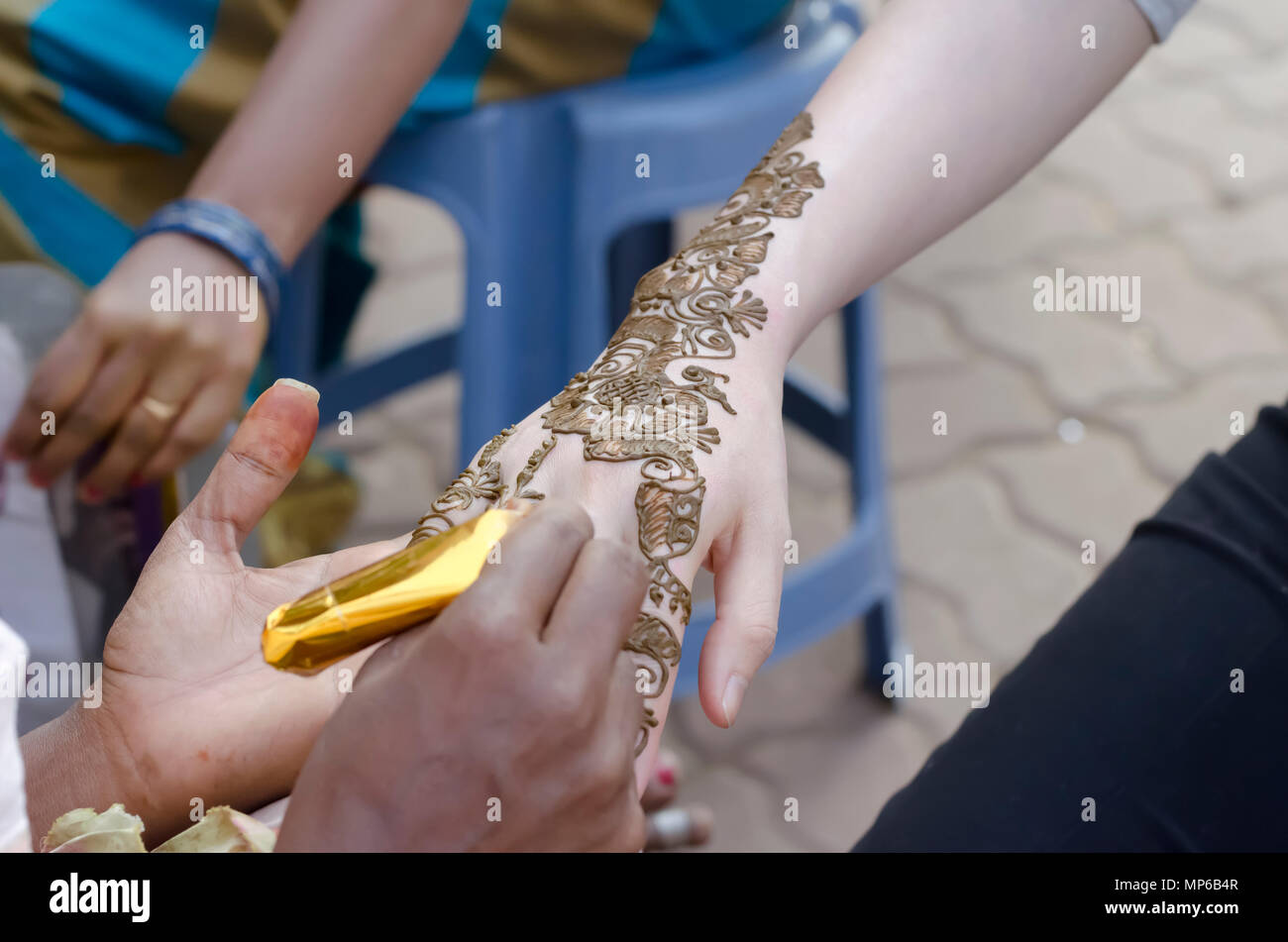 A henna artist at Shilparamam arts and crafts village, Hyderabad, India ...
