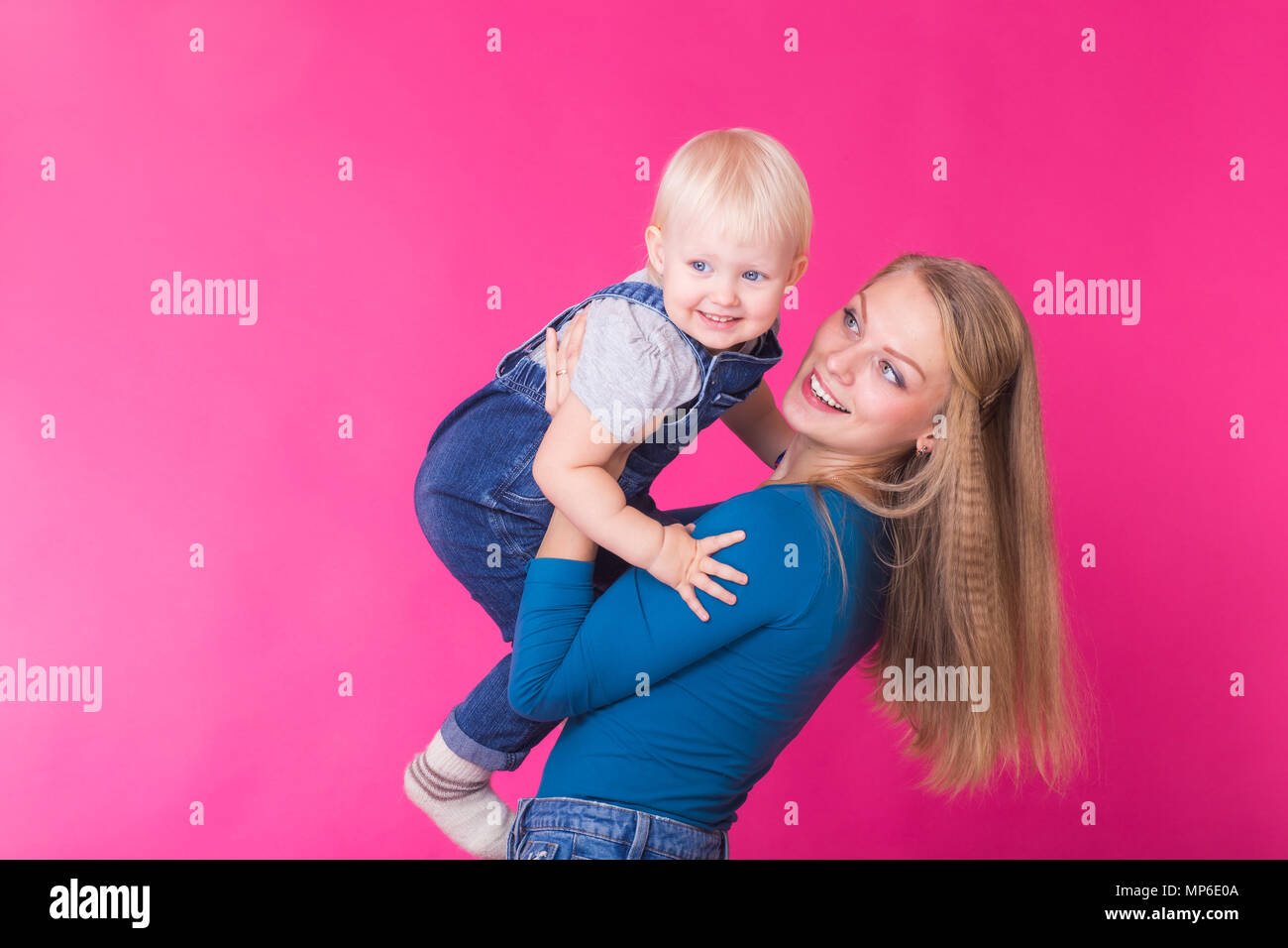 Funny family on pink background. Mother and her daughter girl. Mom and ...