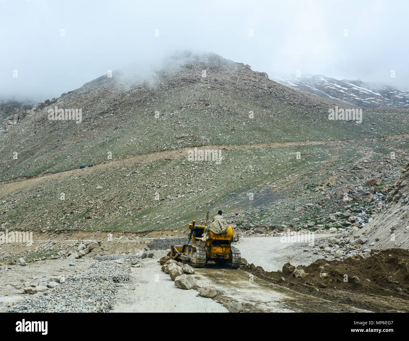 Ladakh, India - Jul 18, 2015. An excavator loader machine working on ...