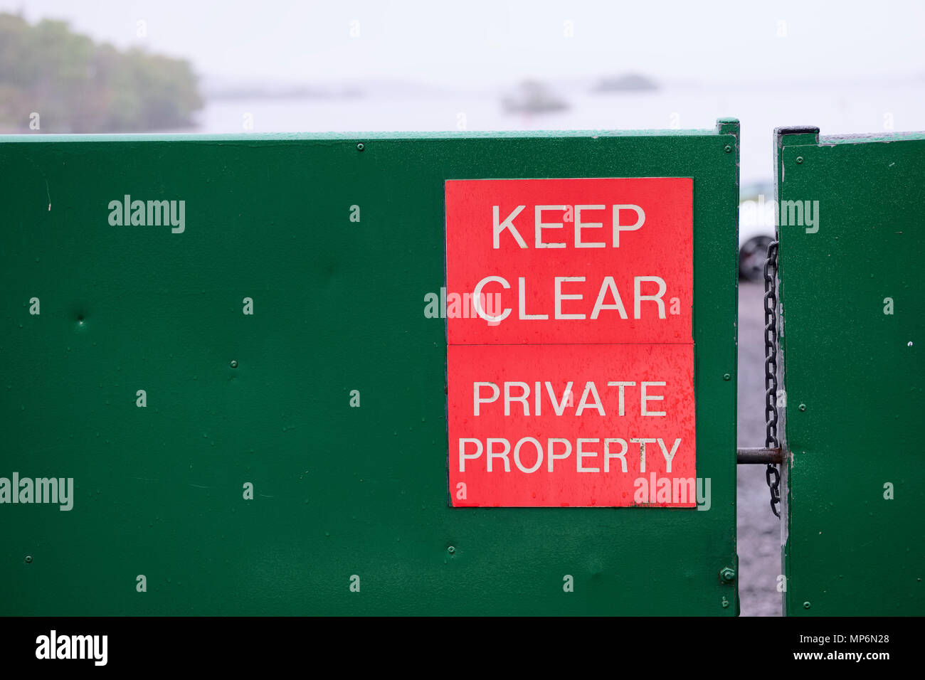 Keep clear private property sign red on green steel closed shut gate ...