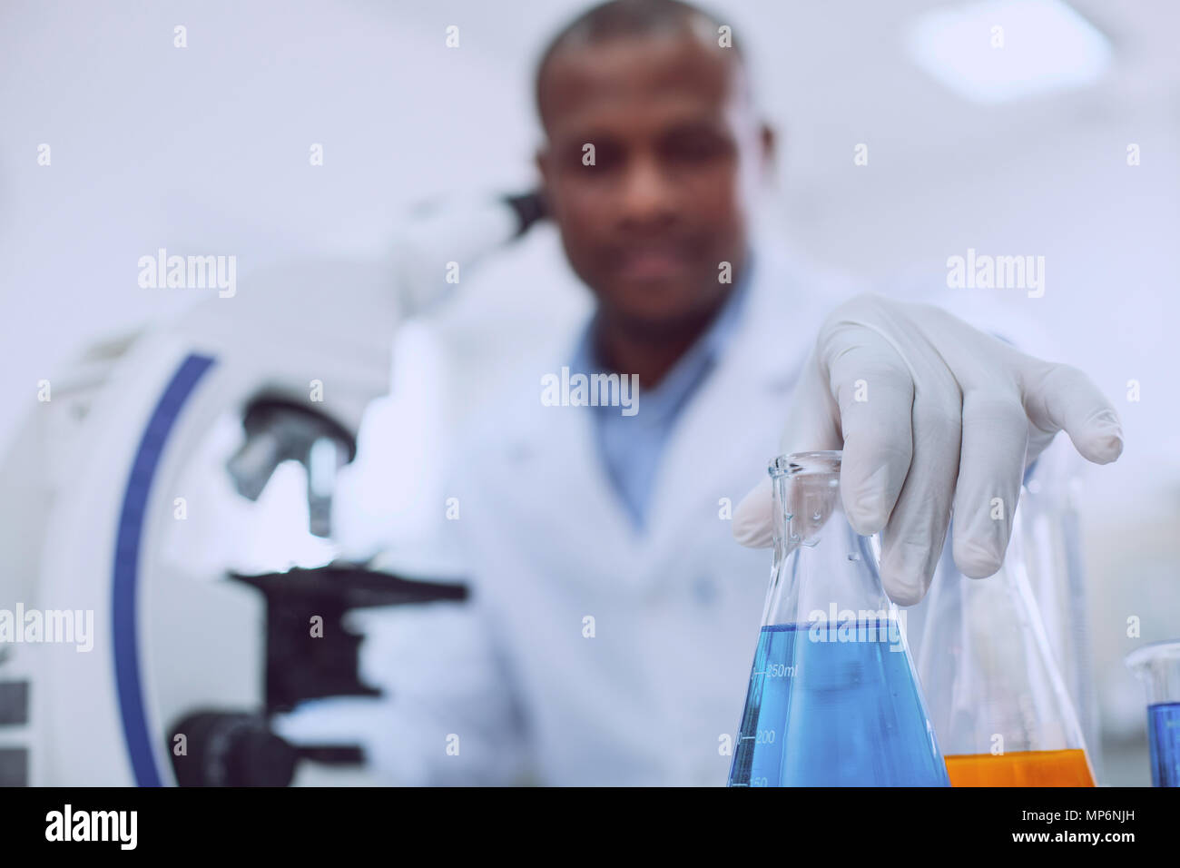 Skilled biologist working with his microscope Stock Photo - Alamy