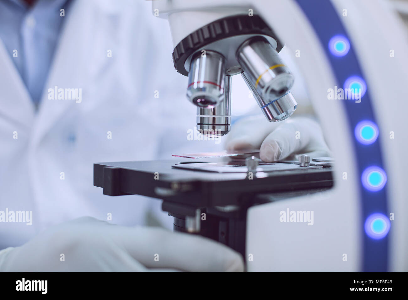 Smart biologist working on a cutting-edge microscope Stock Photo - Alamy