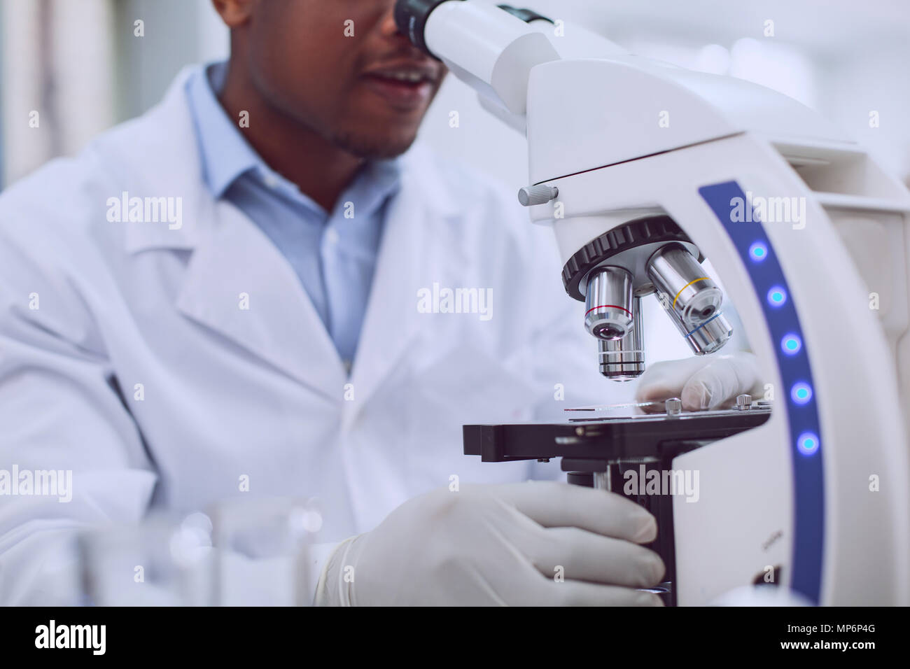 Cheerful biologist working on a cutting-edge microscope Stock Photo - Alamy