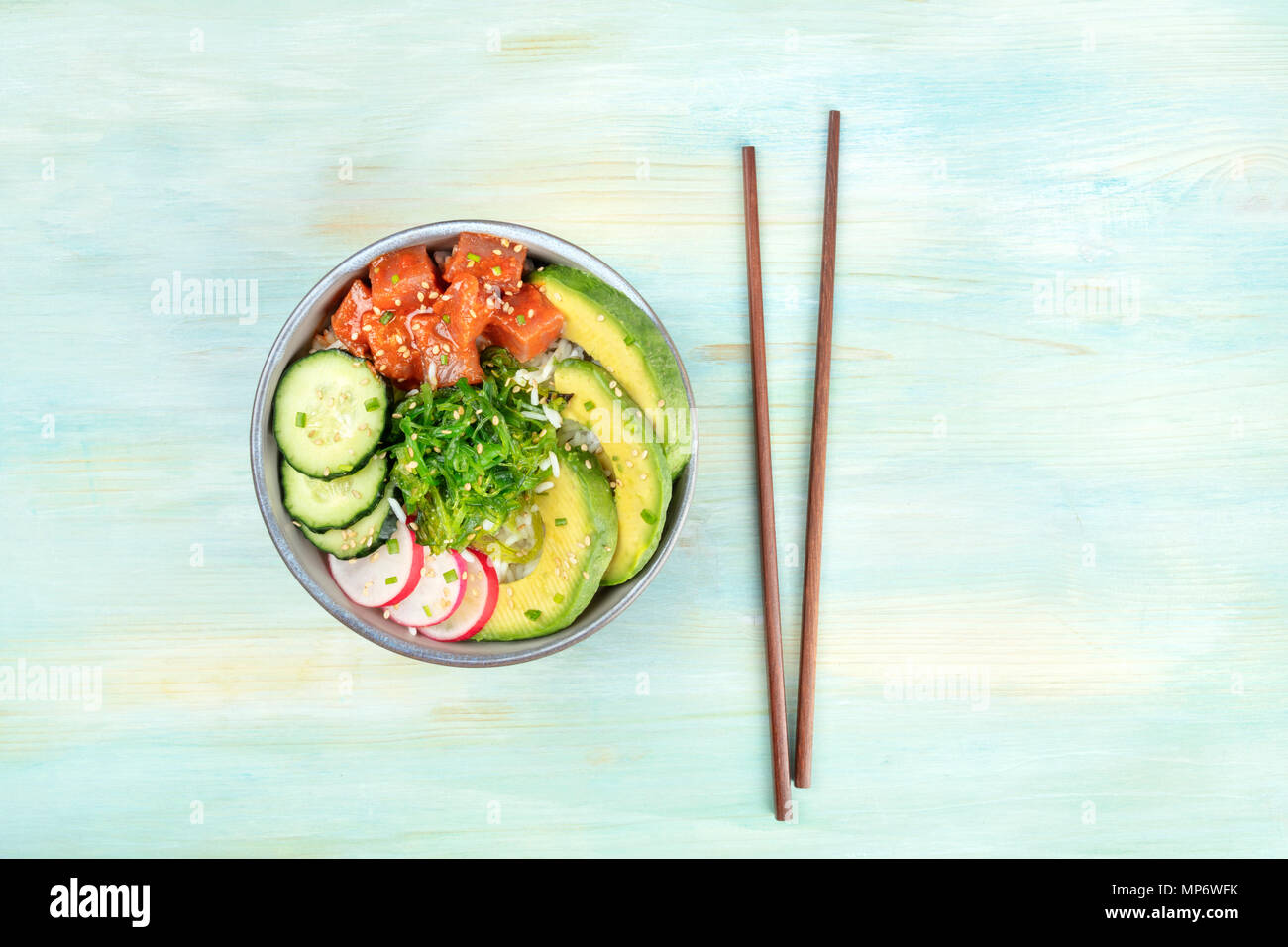 An overhead photo of poke, traditional Hawaiian raw fish salad, with a ...