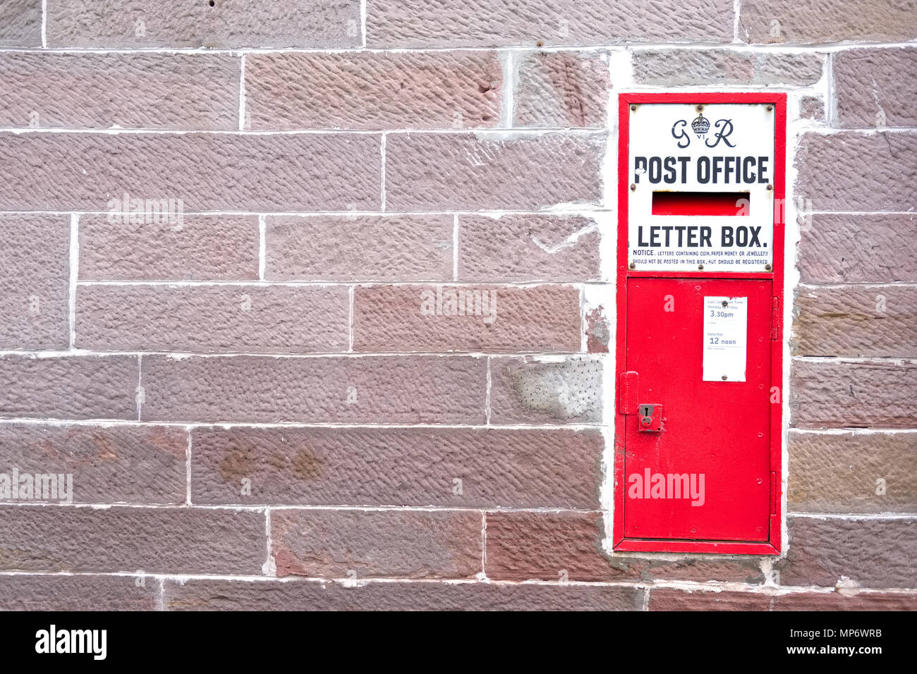 Red post letter box vintage retro in stone wall rural countryside ...