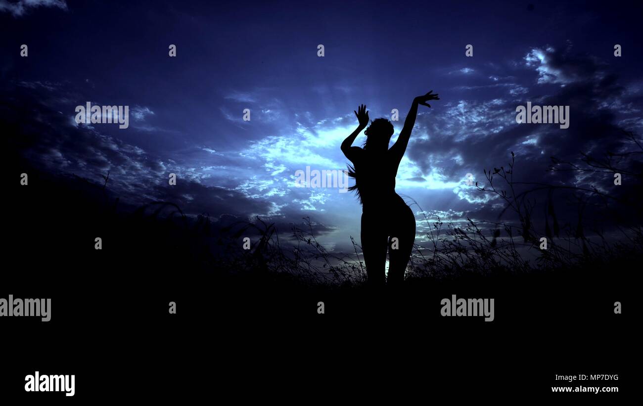 Female black silhouette in night steppe and blue sky background Stock ...