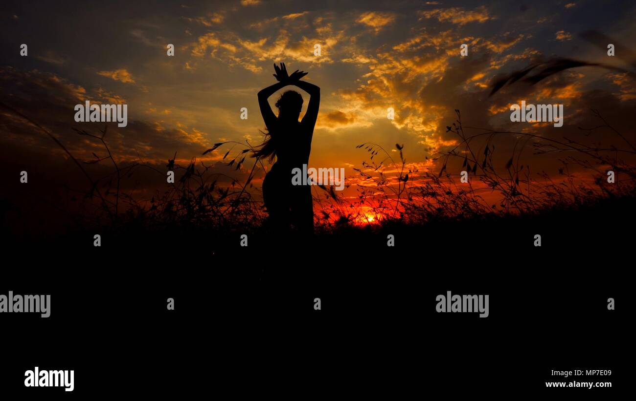 Female shadow silhouette doing yoga in sunset steppe background Stock ...