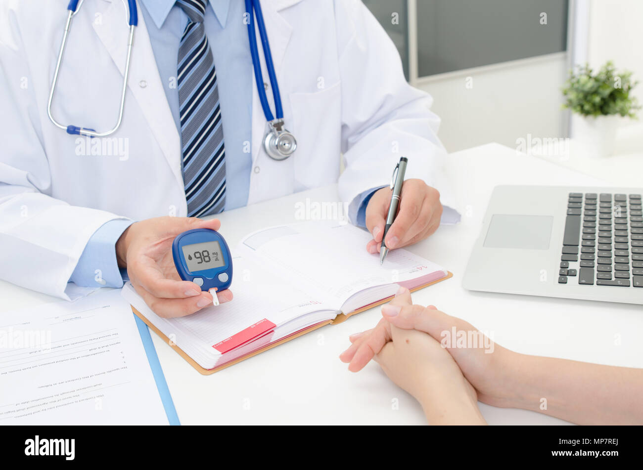 Doctor shows glucometer with glucose level. Doctor and patient diabetes ...