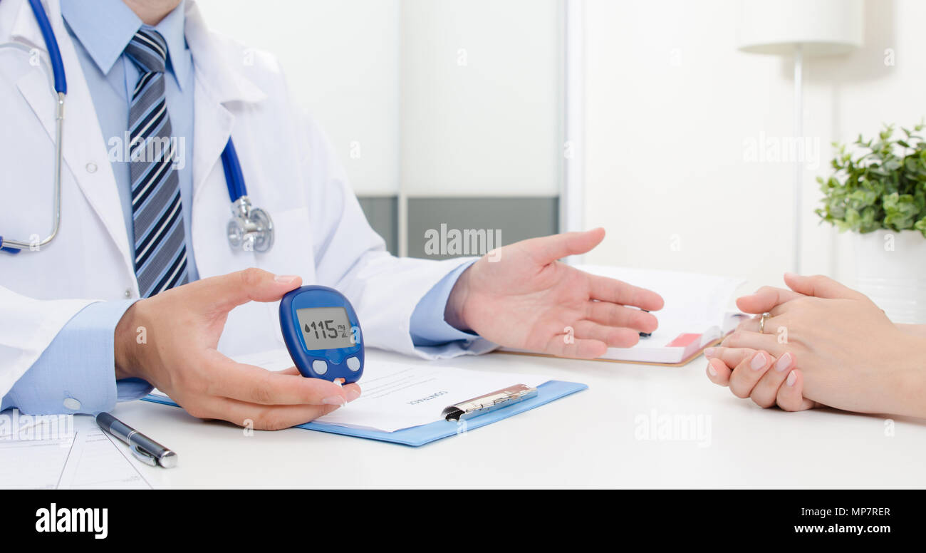 Doctor shows glucometer with glucose level. Doctor and patient diabetes ...