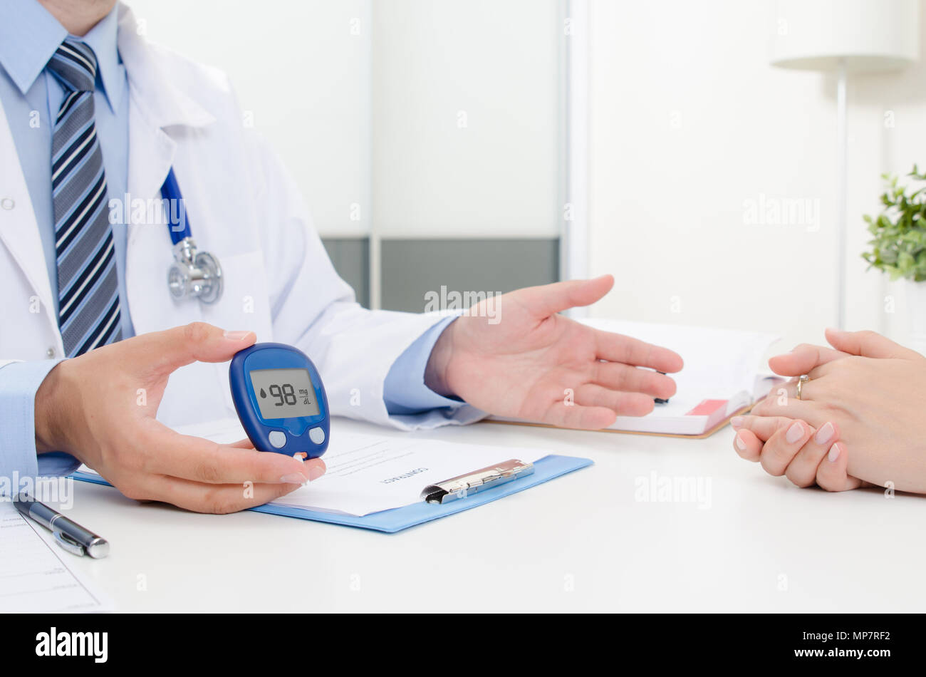 Doctor shows glucometer with glucose level. Doctor and patient diabetes ...