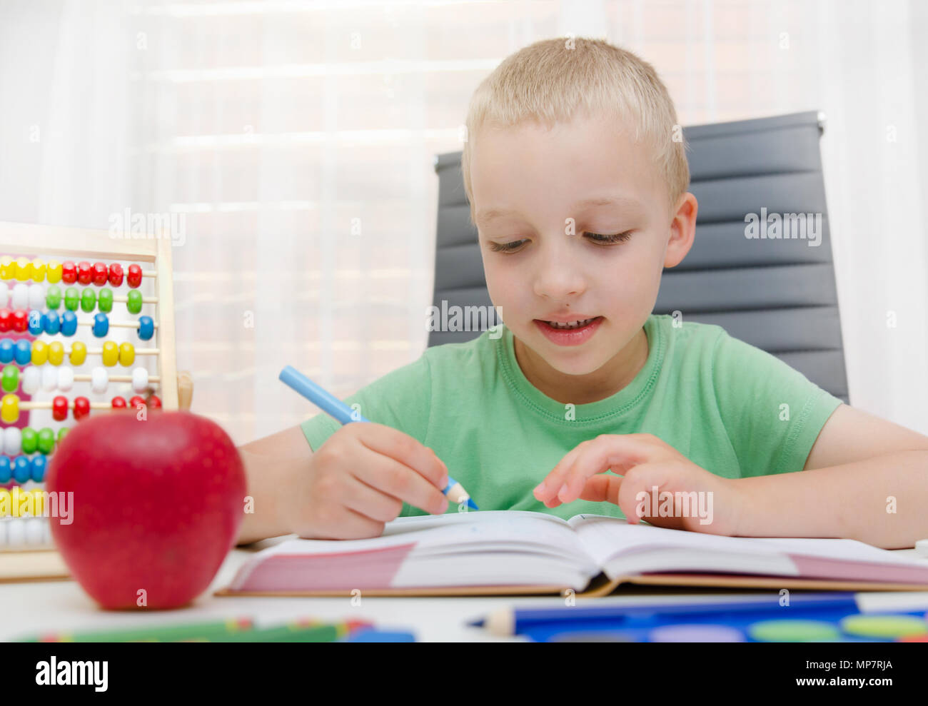 Preschooler, student doing homework at the desk. School child, little ...