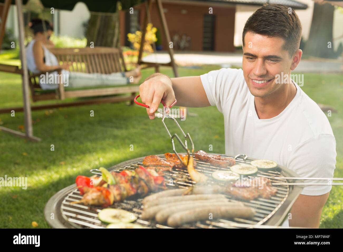 Man woman cook barbecue hi-res stock photography and images - Alamy