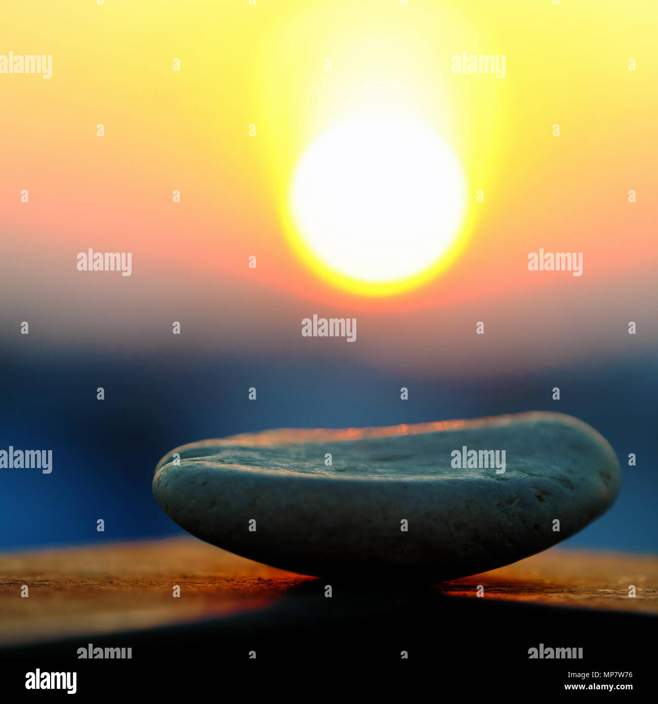 Amazing shape of stack of pebble on yellow sun background at sunrise ...