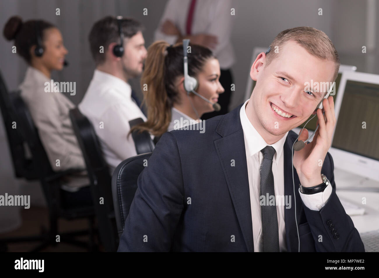 Positive call center operator talking hi-res stock photography and ...
