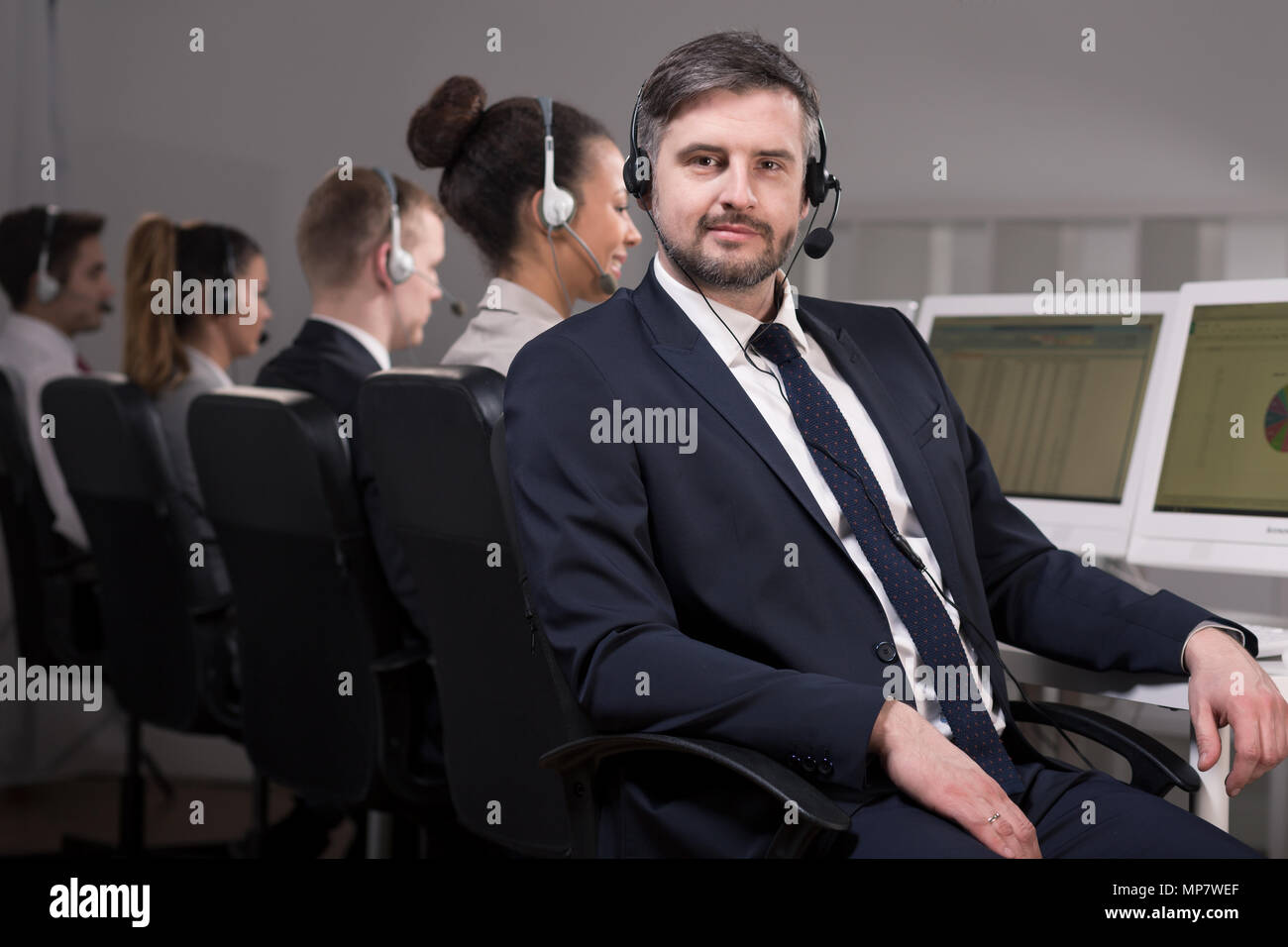 Man in suit with headset working in call center Stock Photo - Alamy