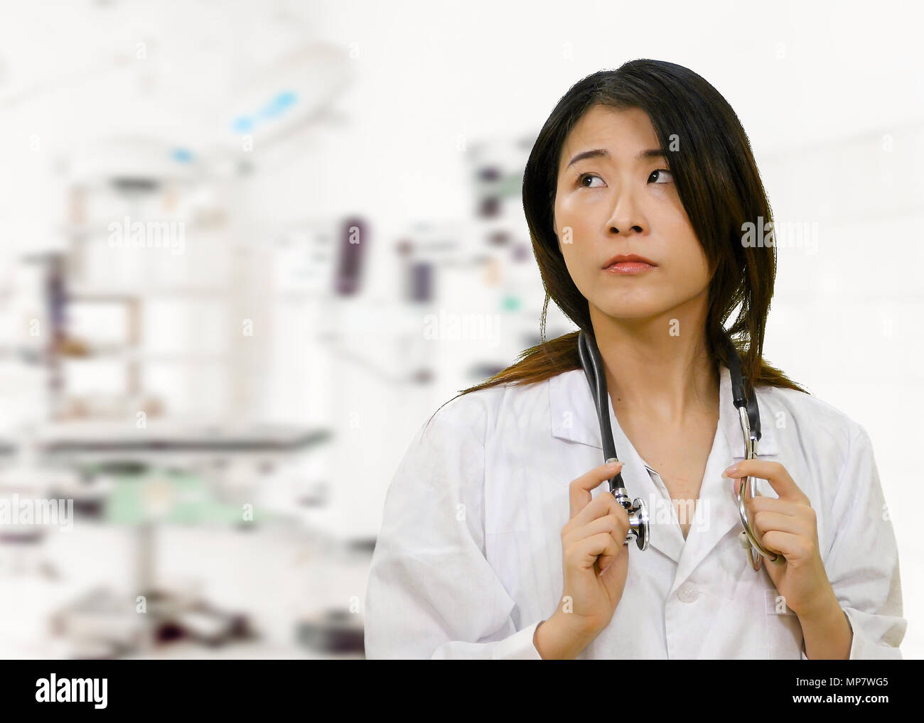 Chinese female doctor in hospital surgery with a worried expression ...